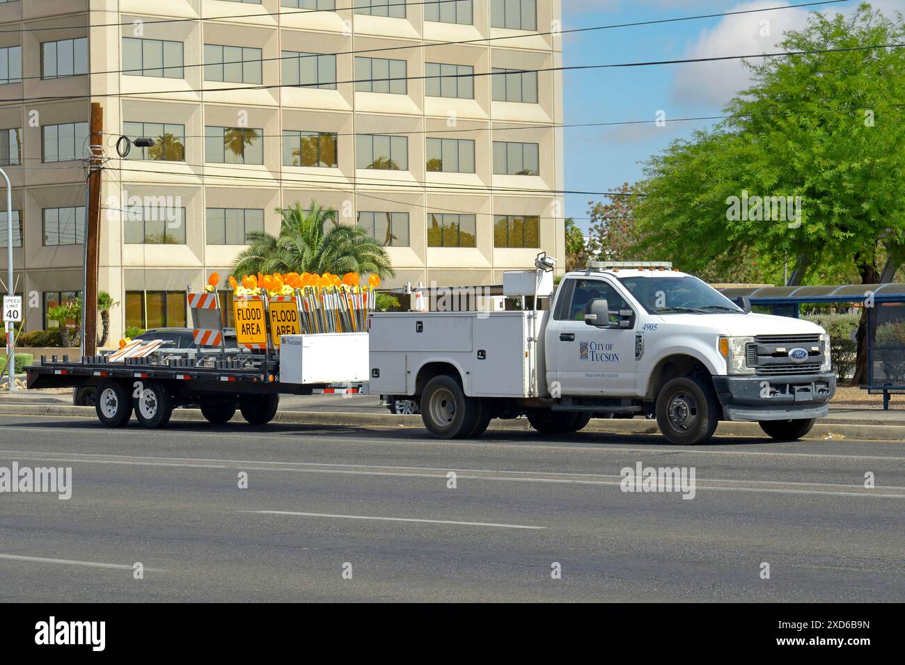 Vehicle trailer with Flood Area signs being towed to designated spots ...