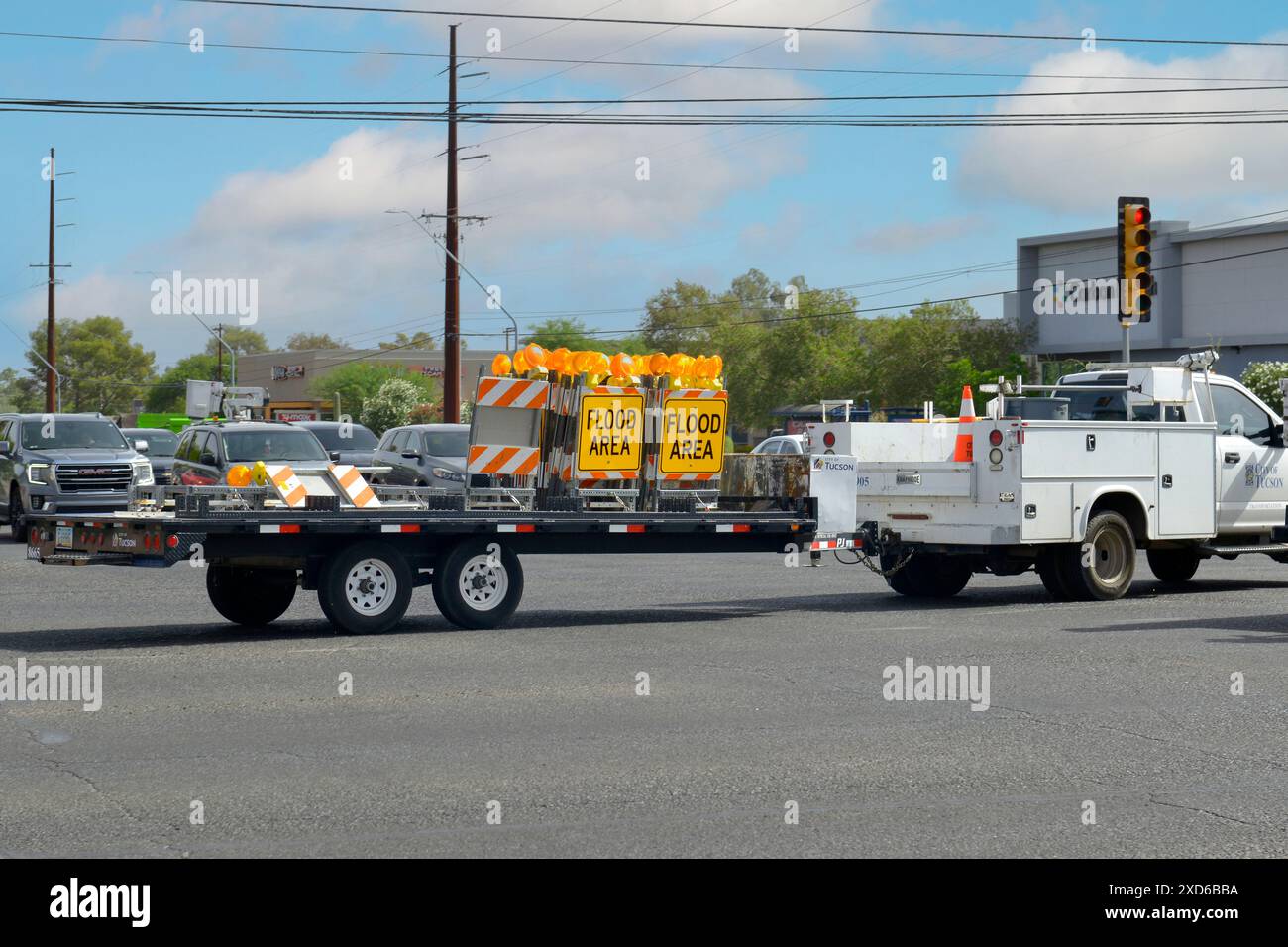 Vehicle trailer with Flood Area signs being towed to designated spots ...