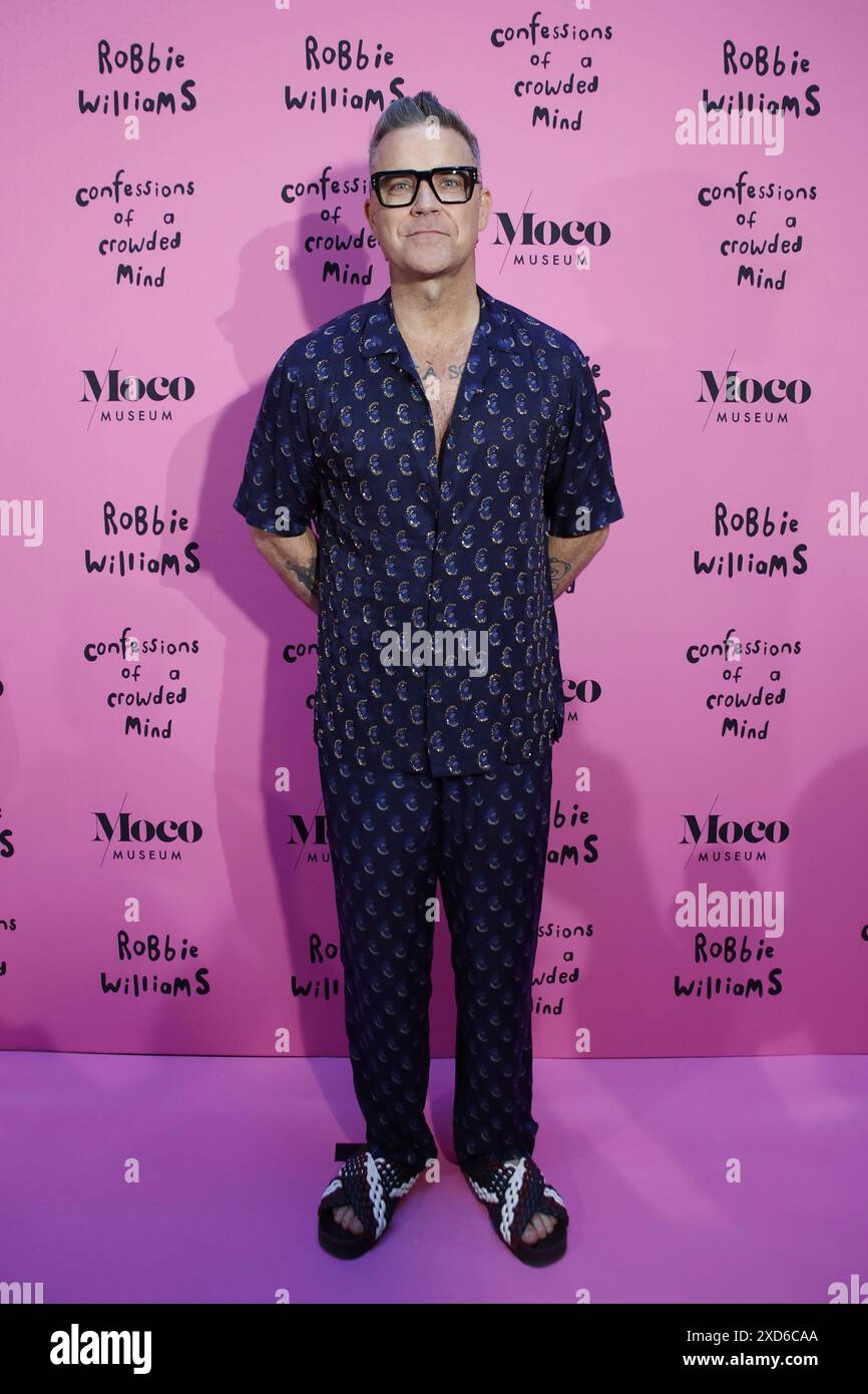 Singer Robbie Williams poses at the photocall of the exhibition ...