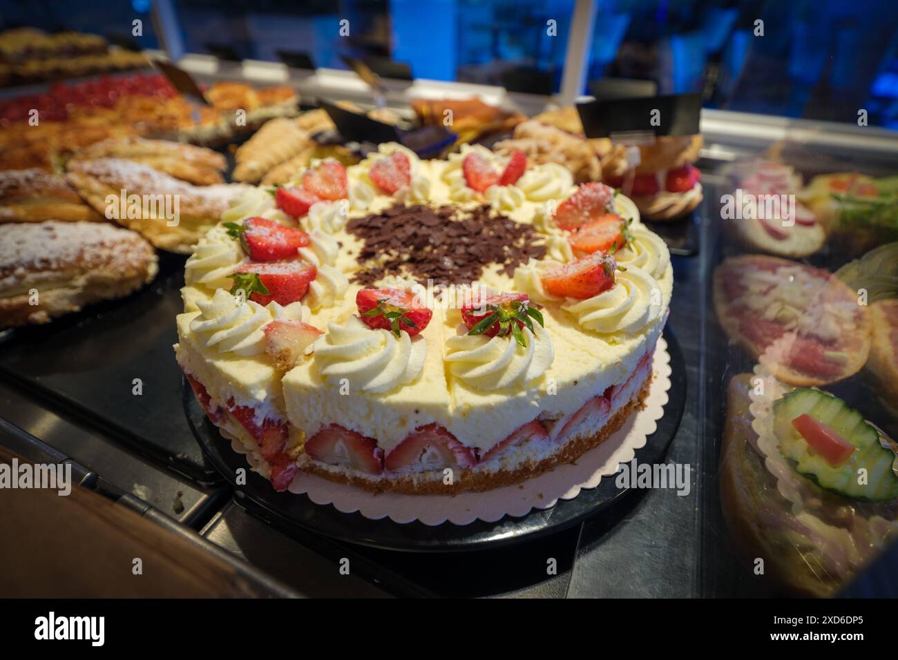 a freshly baked strawberry tart lies in the display of a bakery Stock ...