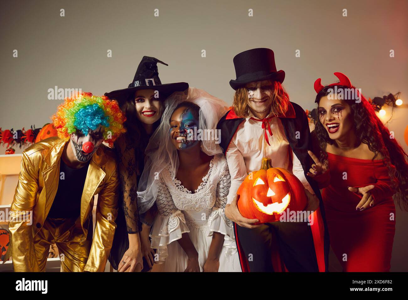 Group of friends dressed as spooky monsters having fun at Halloween ...