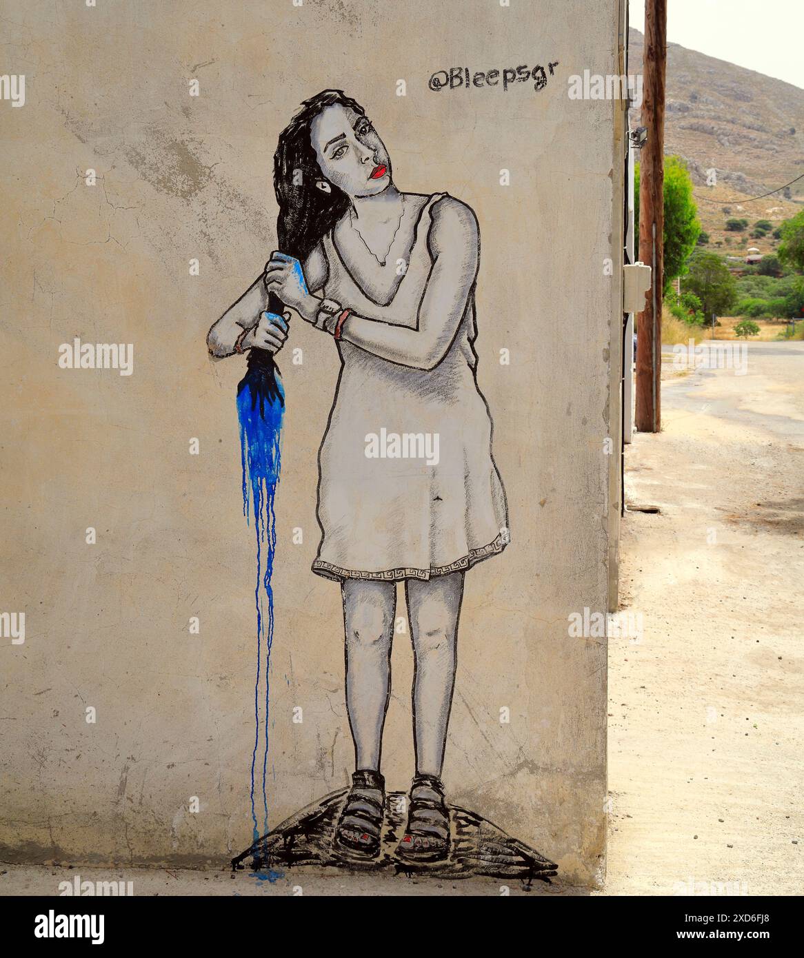 Street scene - street art on the side of a building of a woman washing ...