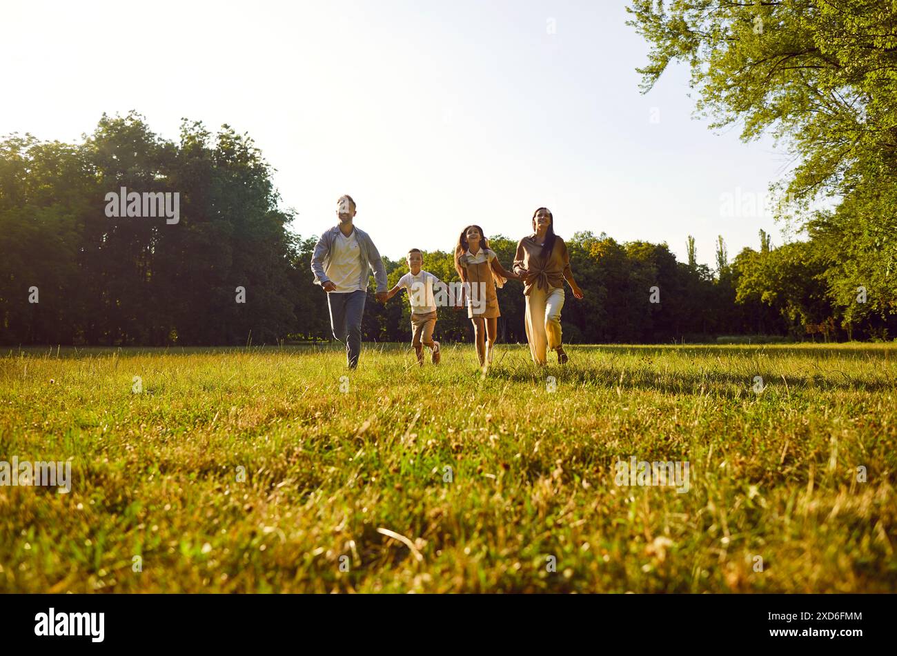 Happy smiling family with kids walking in summer park enjoying ...