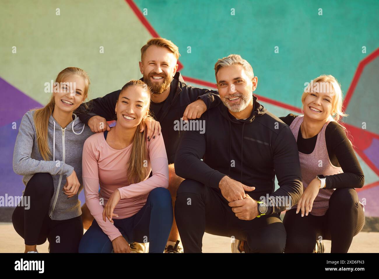 Happy young sport group of people jumping standing in a circle with ...