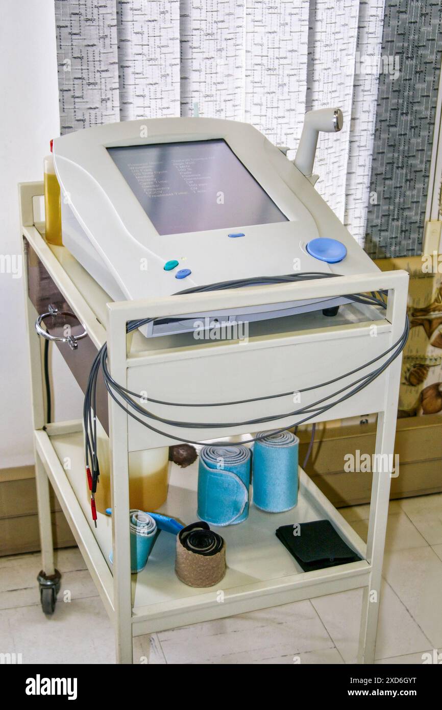modern physiotherapy machine in the room at a clinic, screen on for new ...