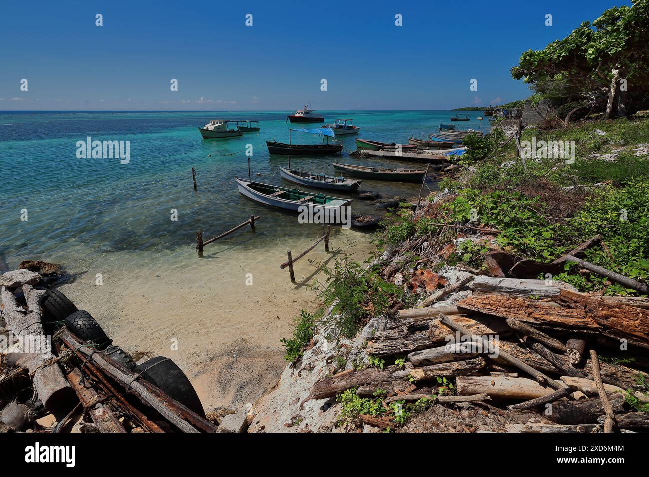 414 Small wood fishing boats moored to wooden stakes in the lagoon ...