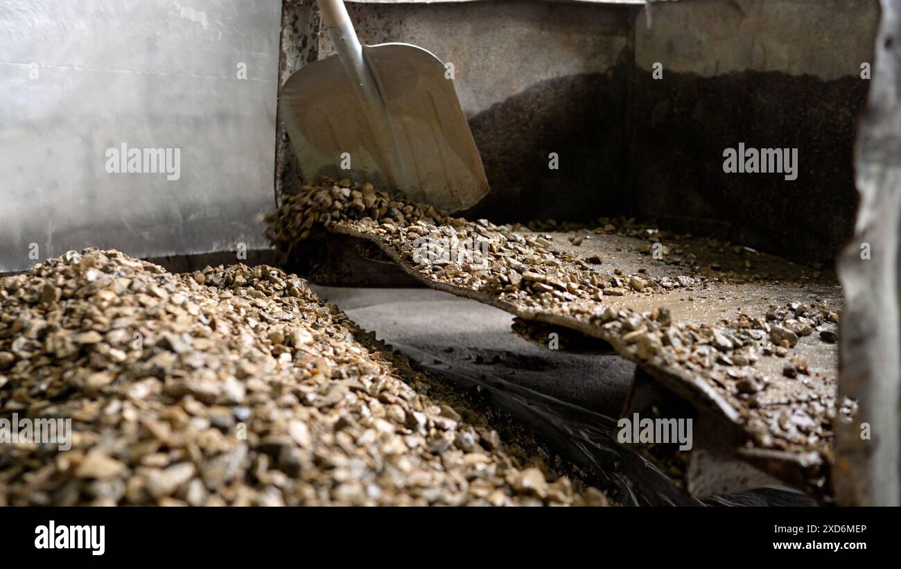 Crushed stone is loaded with a shovel, close-up. Crushed stone is used ...