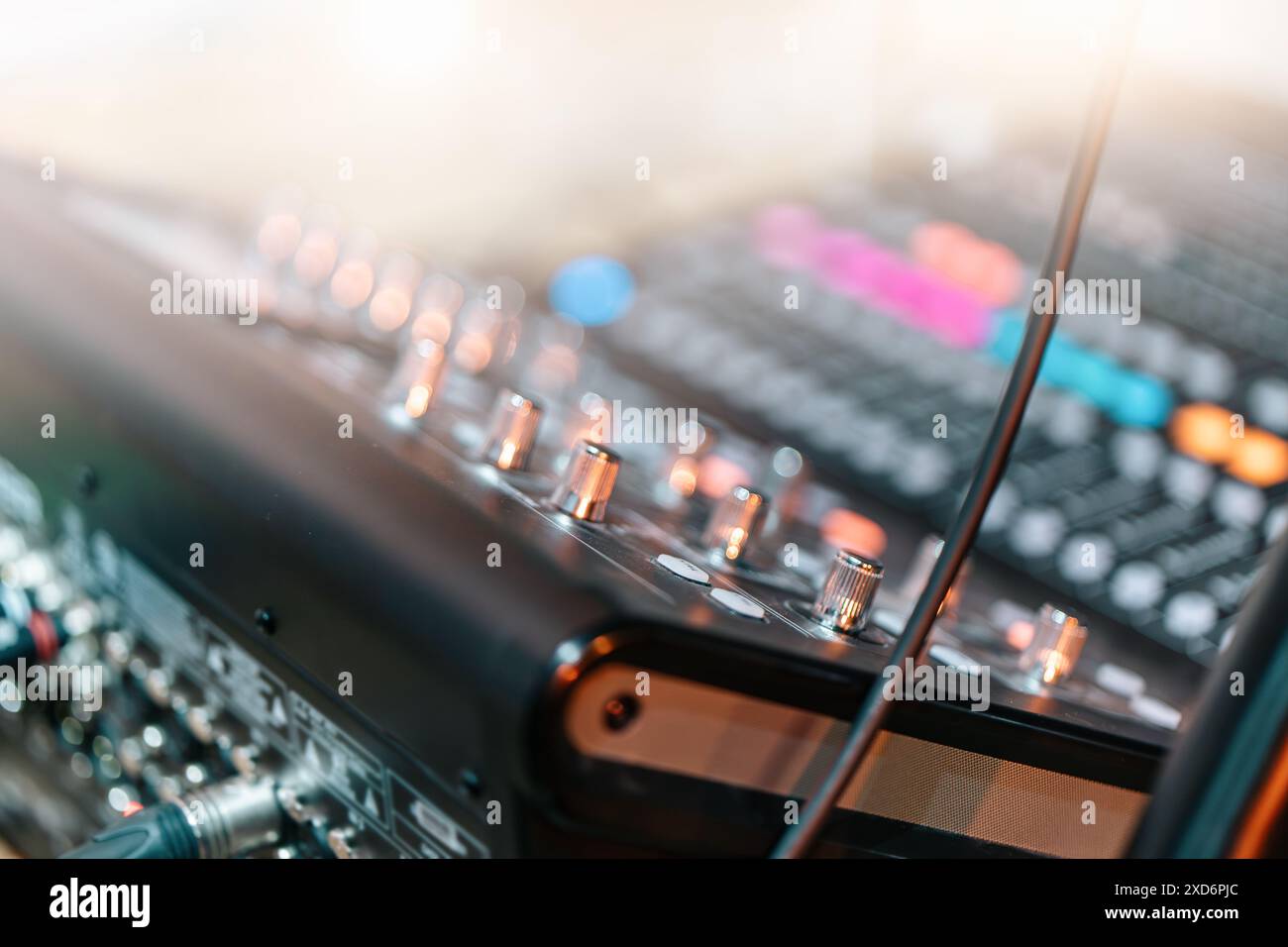 audio mixing console in music production studio, focus on control knobs ...