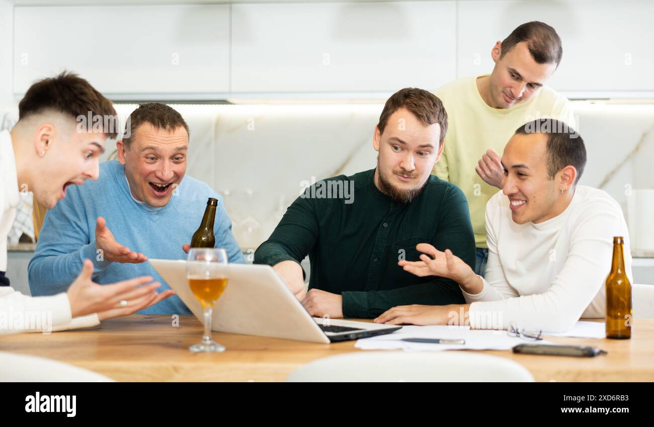 Happy male friends exulting after successful virtual investment Stock ...