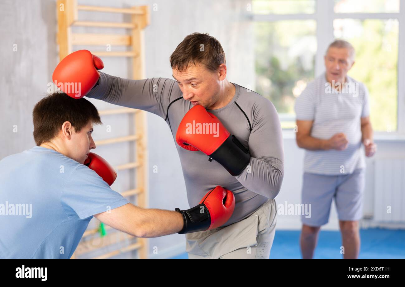 Two men training boxing fight in studio Stock Photo - Alamy