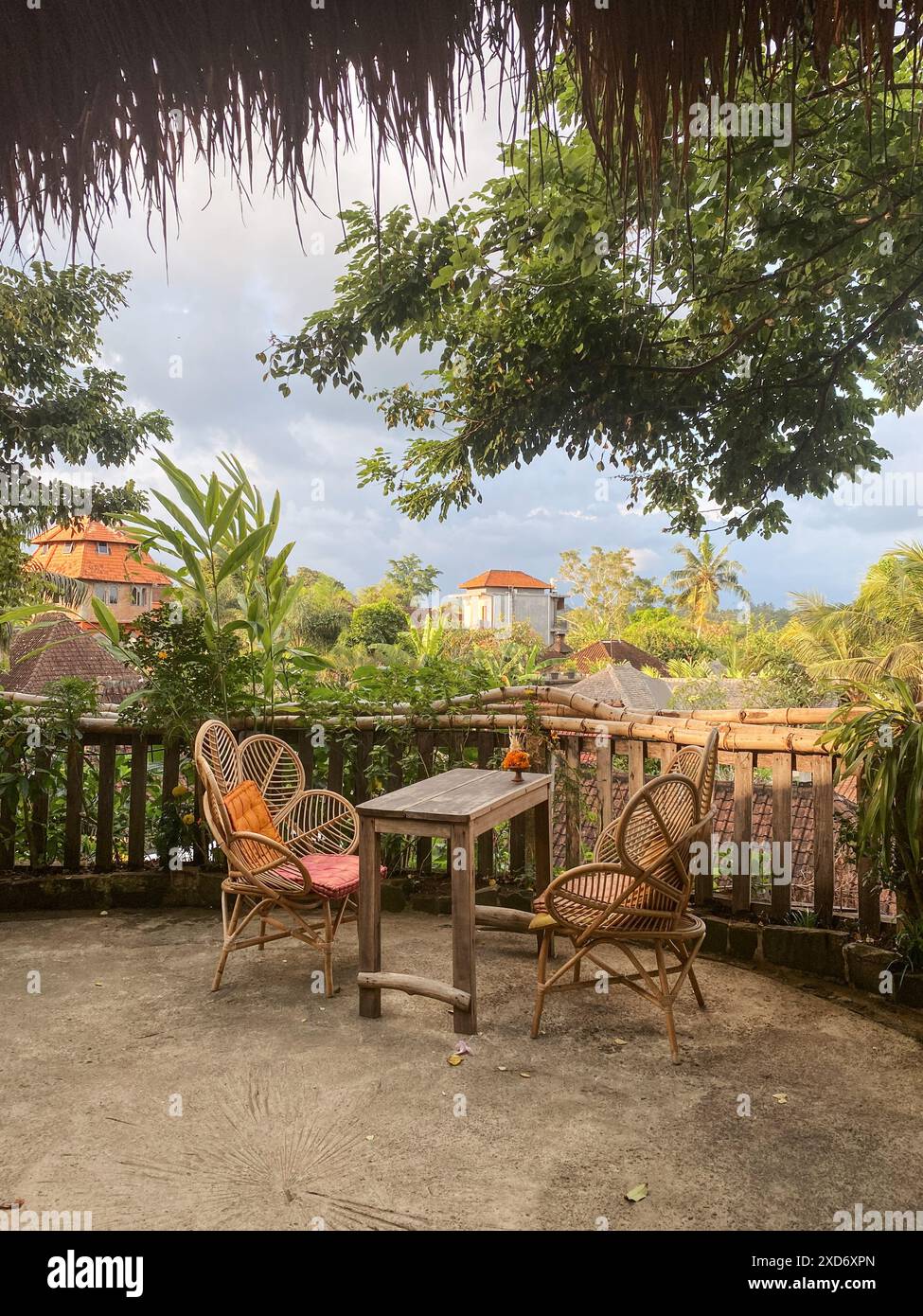 Traditional Bali style outdoor cafe in Ubud, table and two chairs with ...