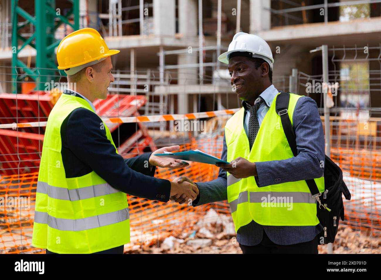 Two confident civil engineers exchange a friendly handshake Stock Photo ...