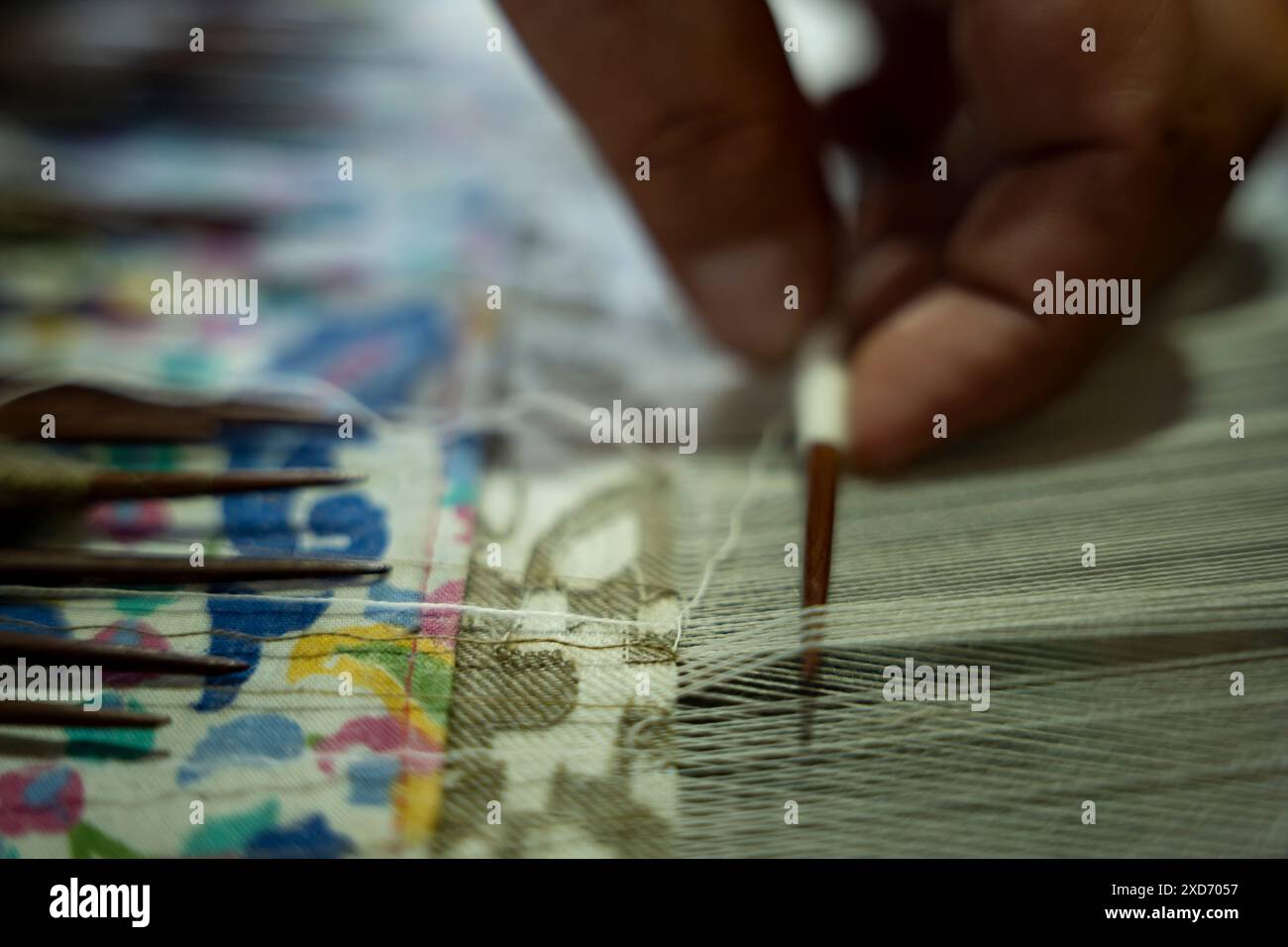 A Kashmiri artisan is using wooden needles and Pashmina yarn to weave a ...
