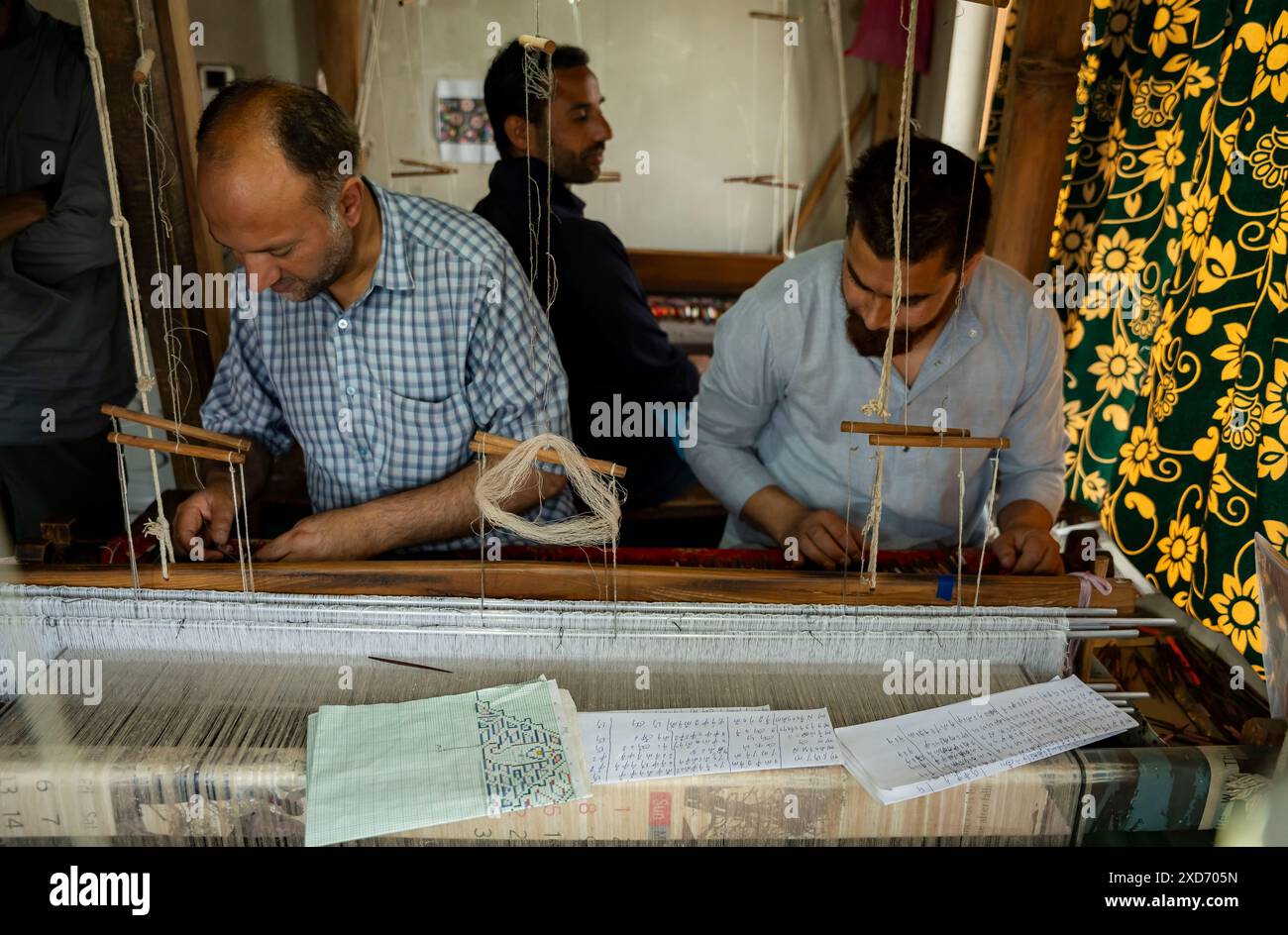 Kashmiri artisans are seen weaving a traditional Kani Shawl on a loom ...