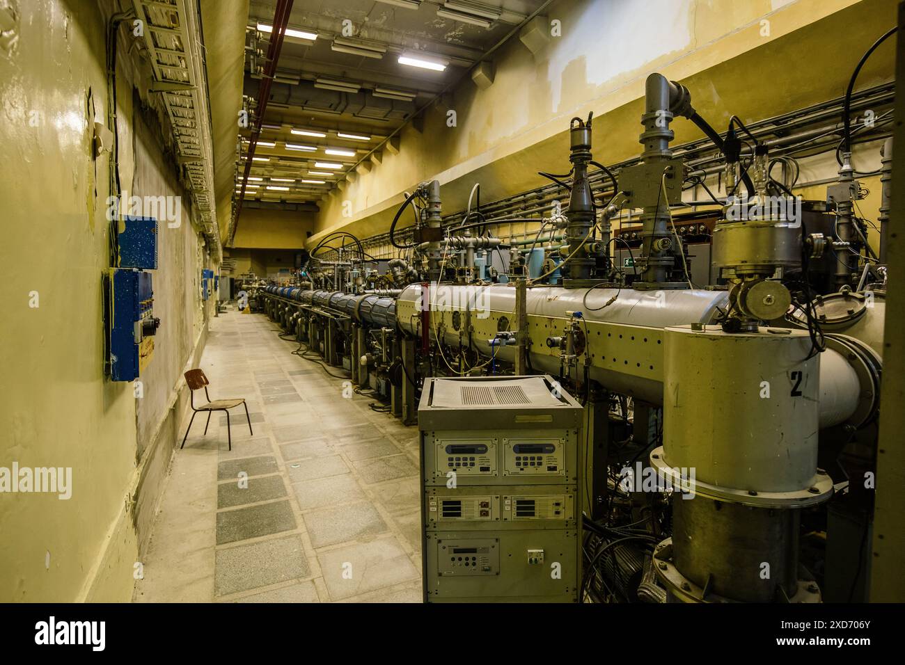 Large metal tube of particle accelerator with connected pipes. Old ...