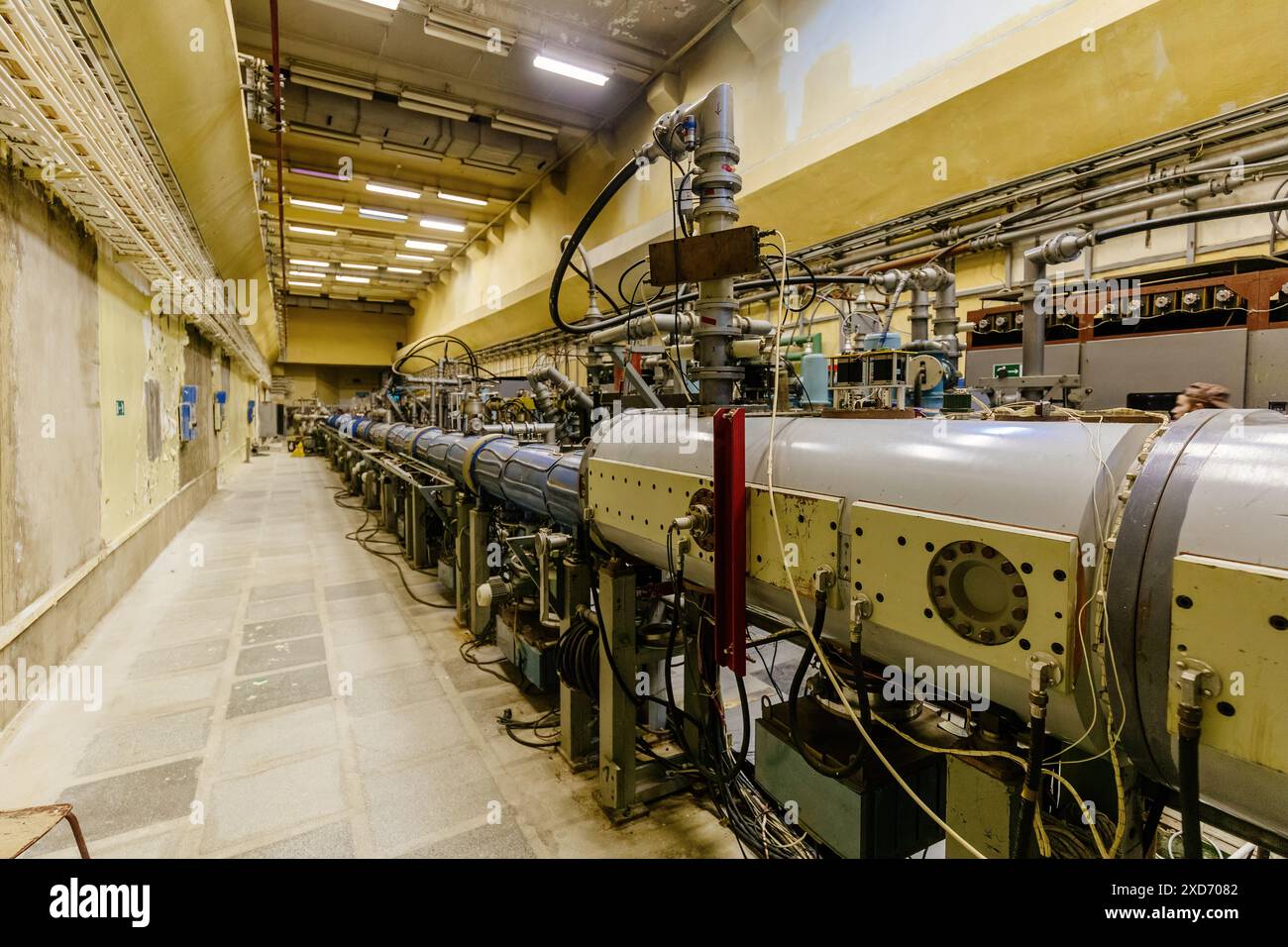 Large metal tube of particle accelerator with connected pipes. Old ...
