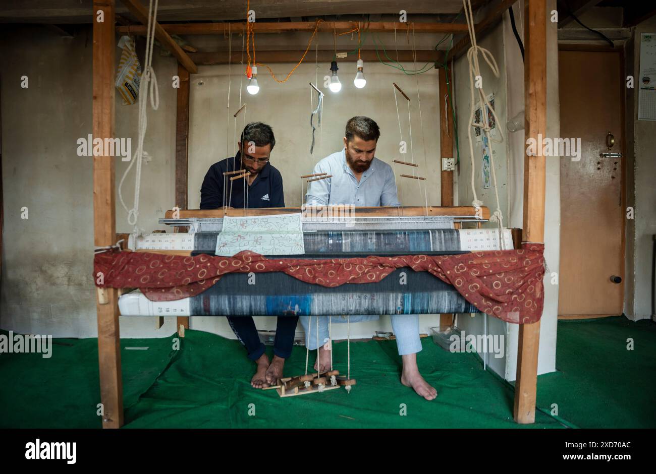 June 20, 2024, Srinagar, Jammu And Kashmir, India: Kashmiri artisans are seen weaving a ...
