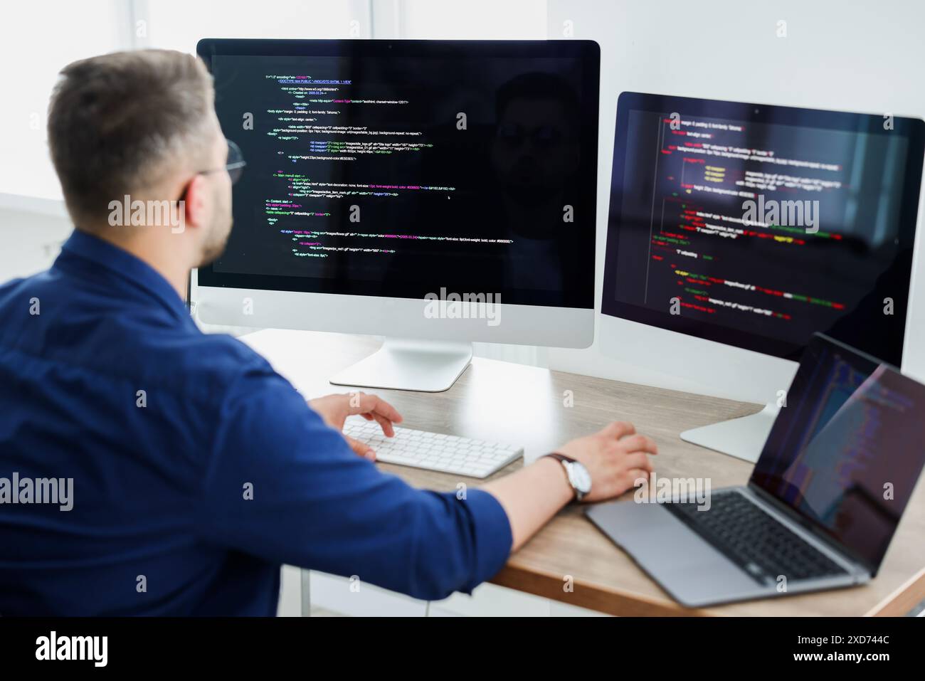 Back view young programmer working hi-res stock photography and images ...