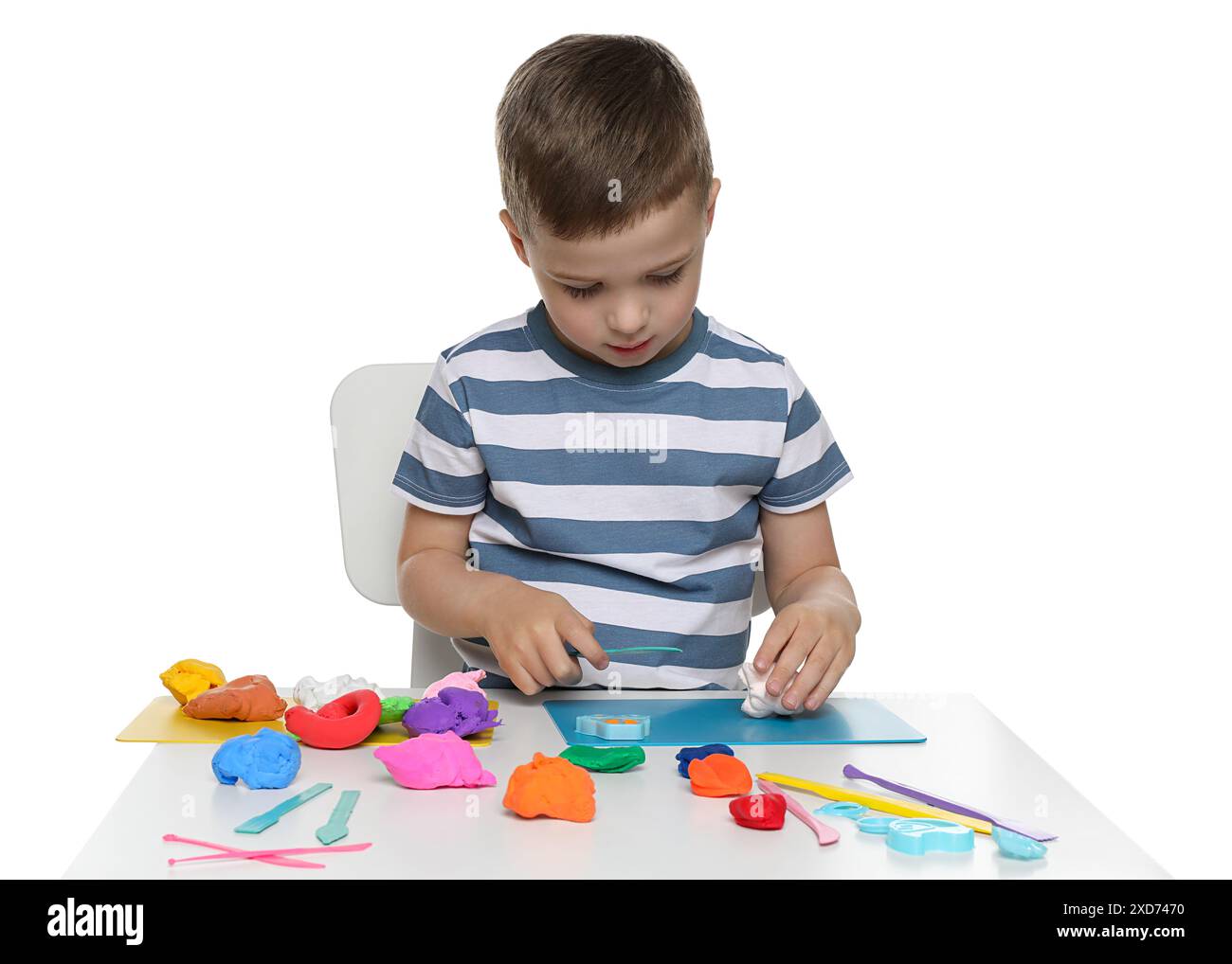 Little boy sculpting with play dough at table on white background Stock ...