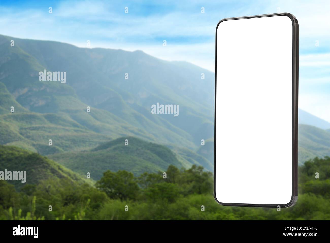 Mobile phone with empty screen against mountain landscape. Space for ...