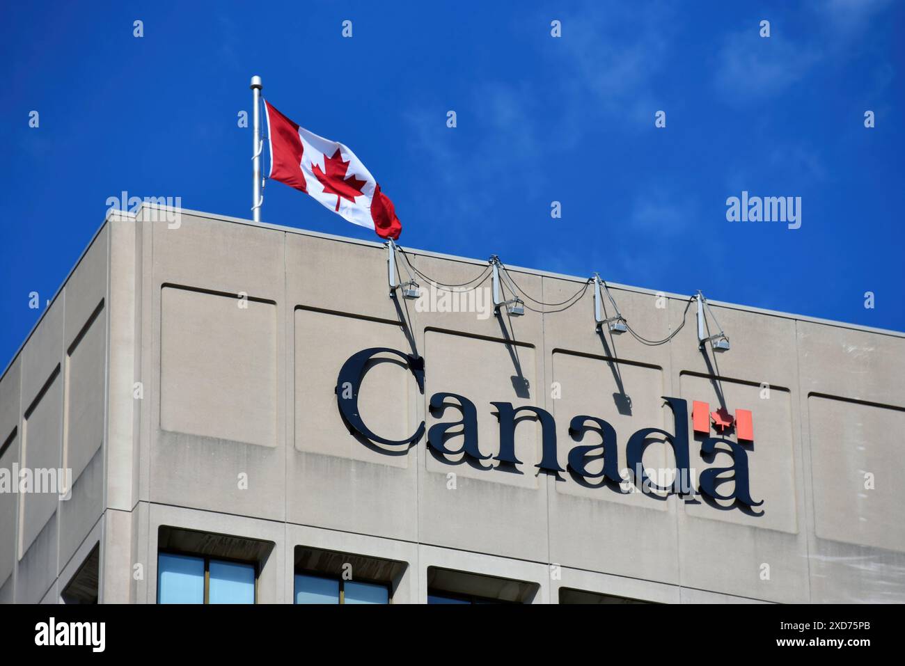 Ottawa, Canada - June 15, 2024: Canadian flag and Canadian government logo at DND building on ...