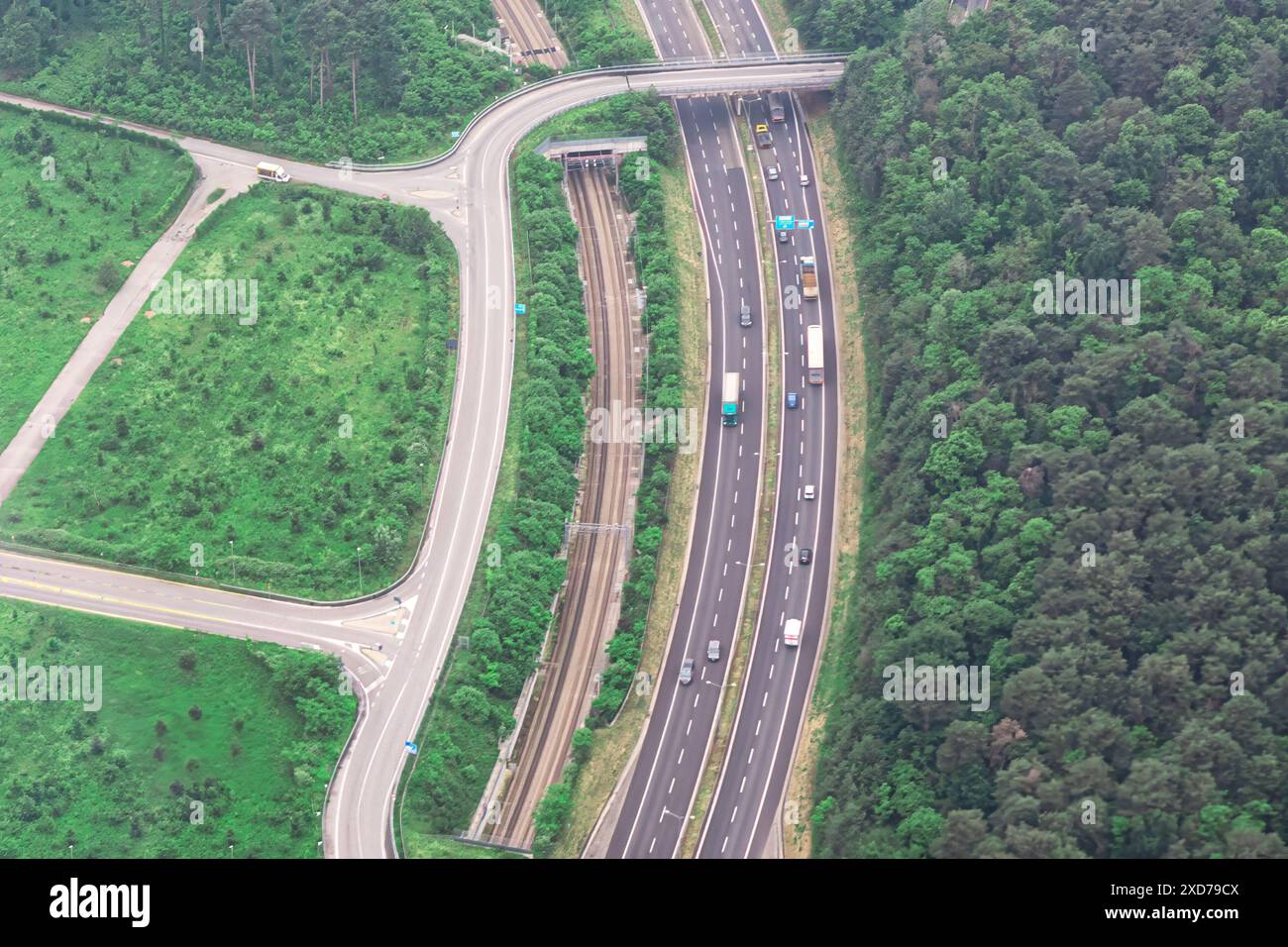 Aerial view of road in the forest with car traffic on the road. Scenic ...