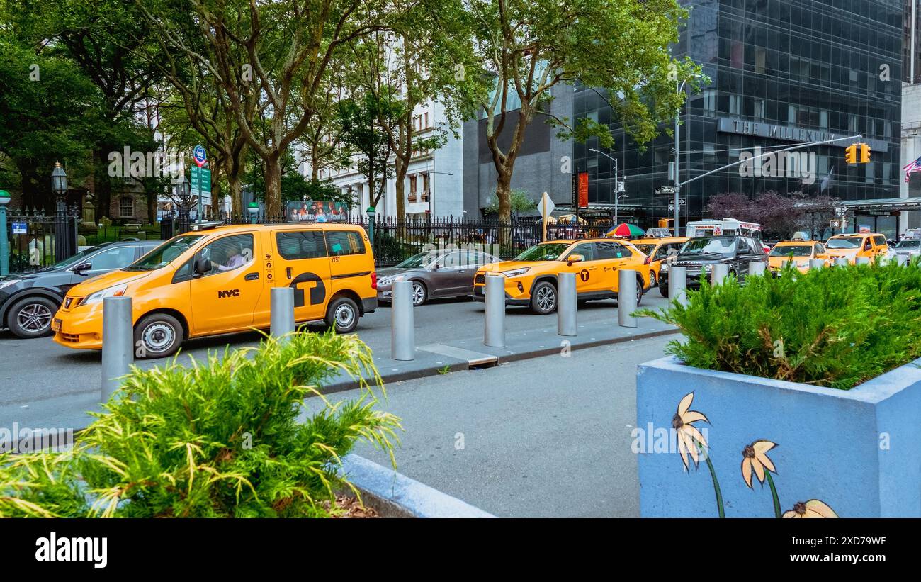 Yellow taxi cab in city street with skyscrapers and office buildings ...