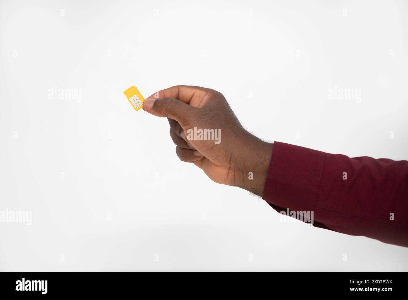 black Hand holding yellow SIM card over white background Stock Photo ...