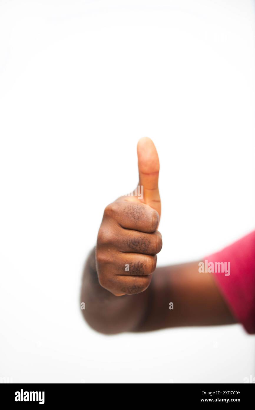 black Hand making thumbs up sign gesture over white background Stock ...