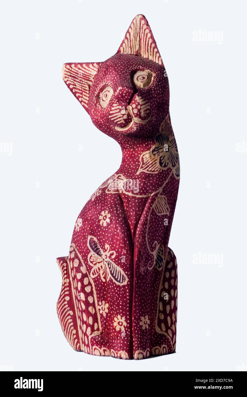 Cat statue is made of wood, and is painted with batik motif, isolated ...
