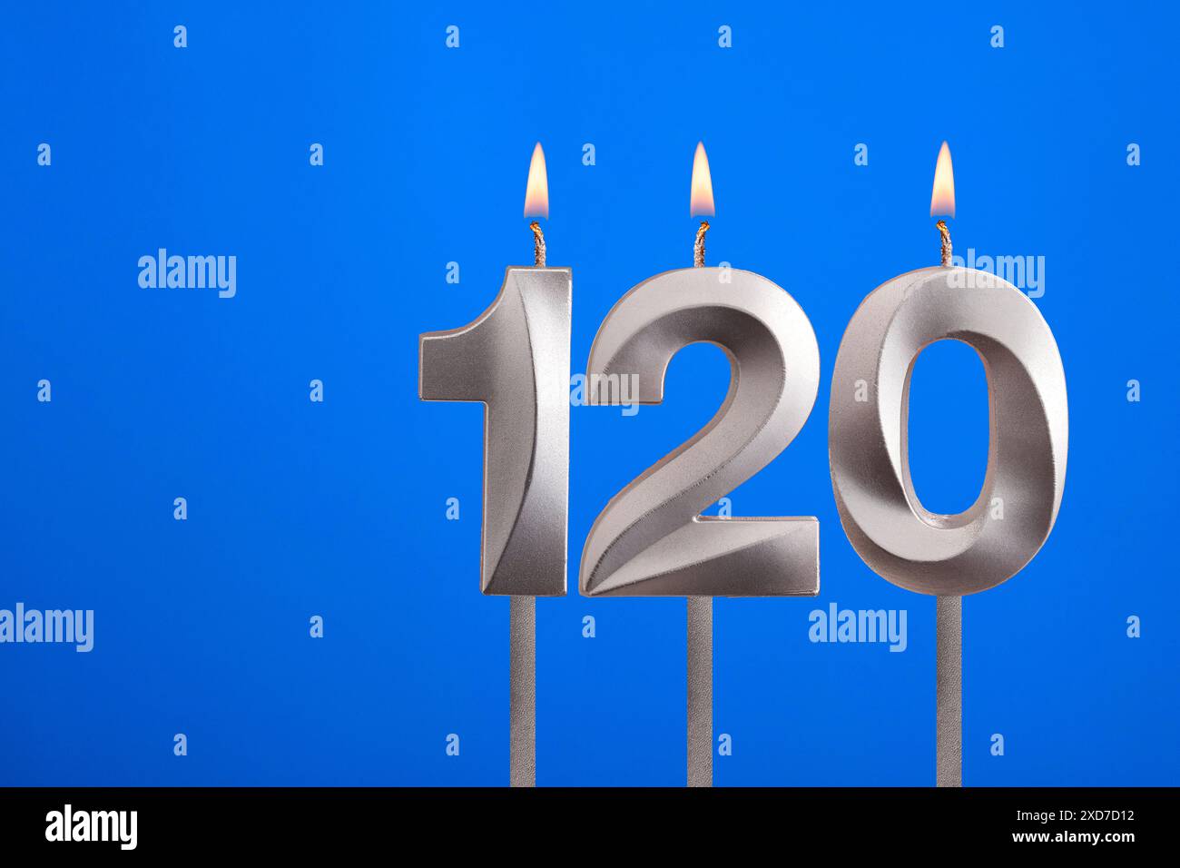 Birthday number 120 - Candle lit on blue background Stock Photo - Alamy