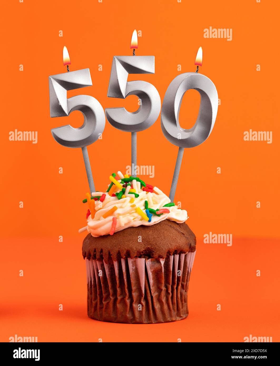 Number 550 candle - Birthday cupcake on orange background Stock Photo ...