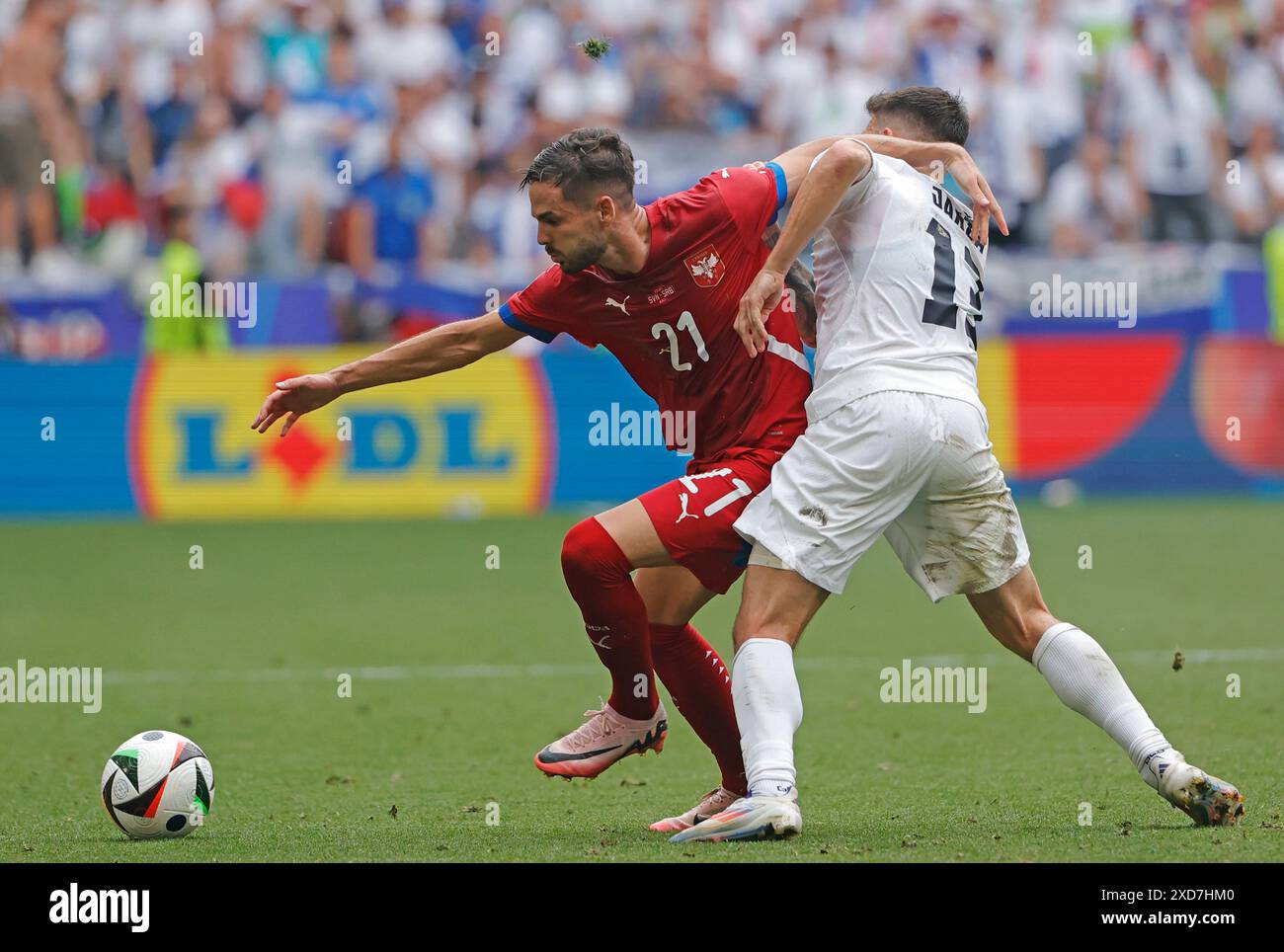 Munich, Germany. 20th June, 2024. Mijat Gacinovic (L) of Serbia vies ...