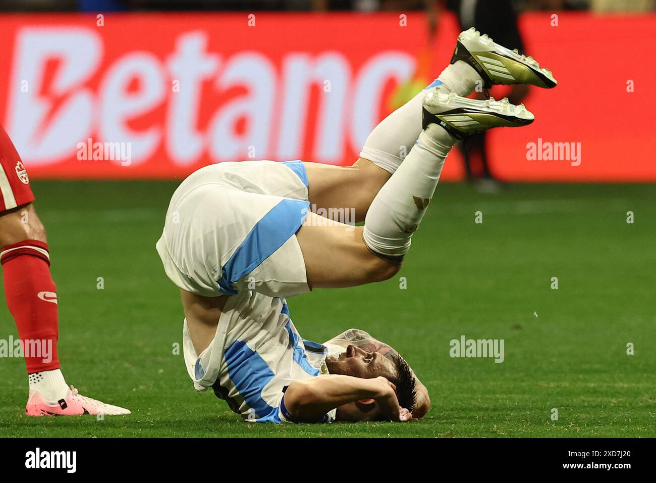 Argentina's forward Lionel Messi (C) falls on the field during the Copa ...