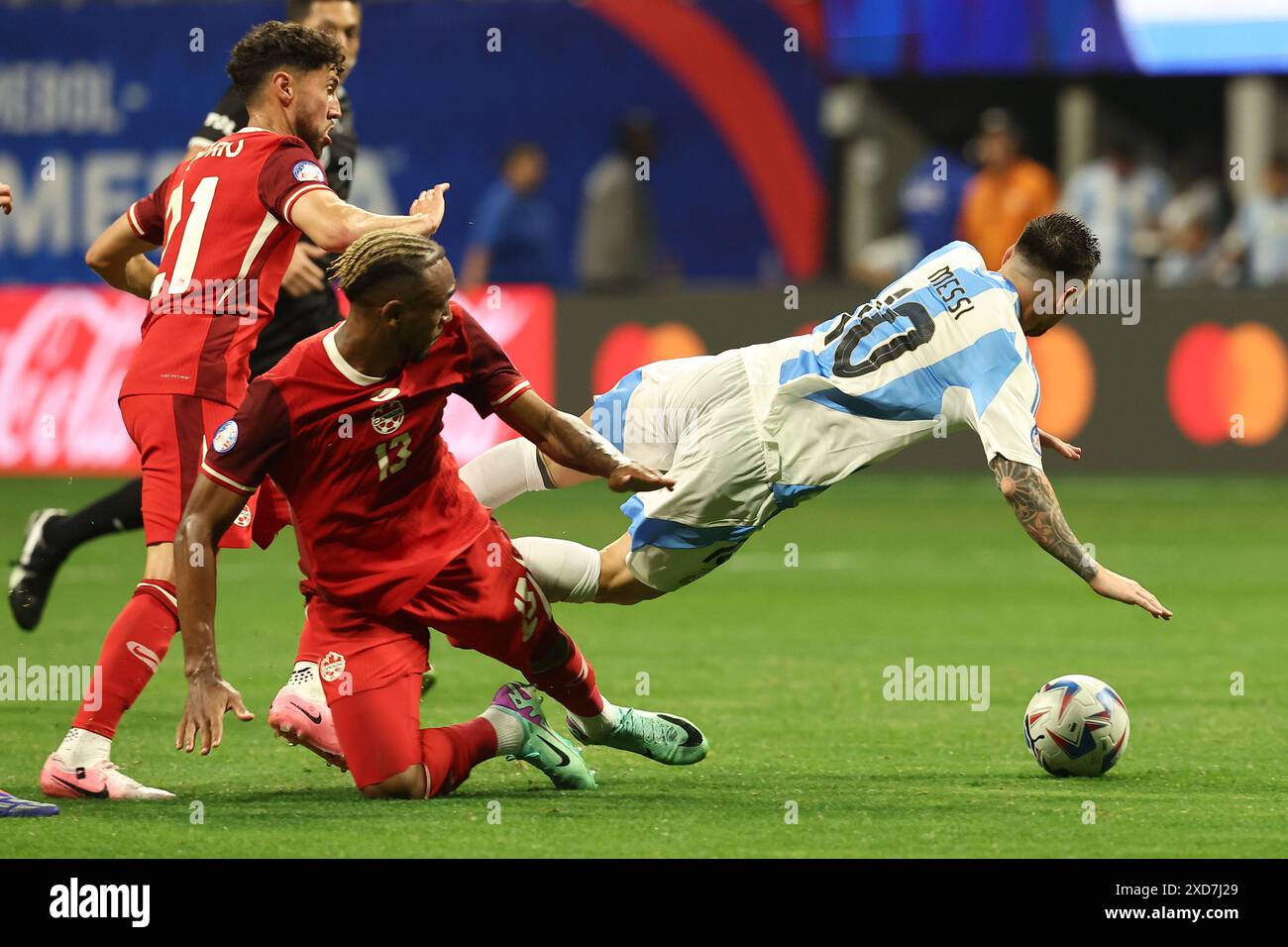 Argentina's forward Lionel Messi (R) is fouled by Canada’s defender ...