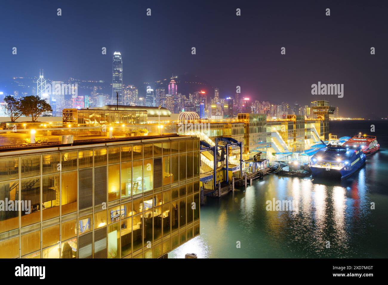 Awesome night view of Hong Kong China Ferry Terminal in Tsim Sha Tsui of Kowloon. Glowing ...