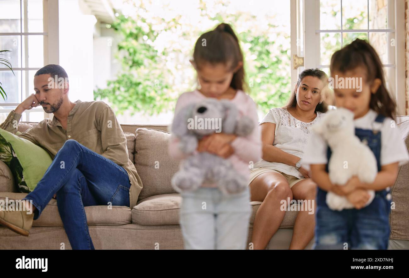Family, fighting and sad girls in living room with teddy bear for ...
