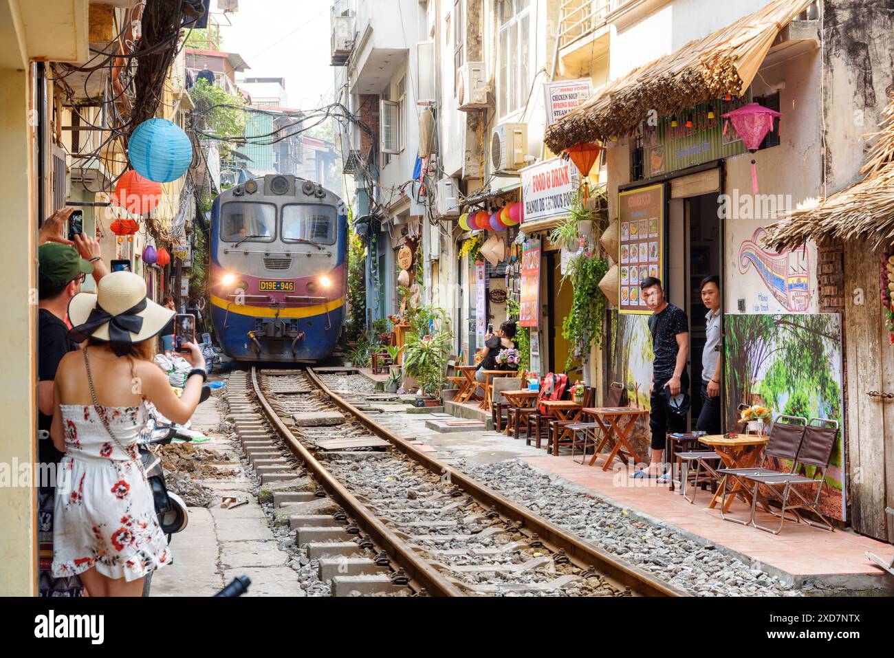 Hanoi, Vietnam - April 18, 2019: View of train passing through a narrow ...
