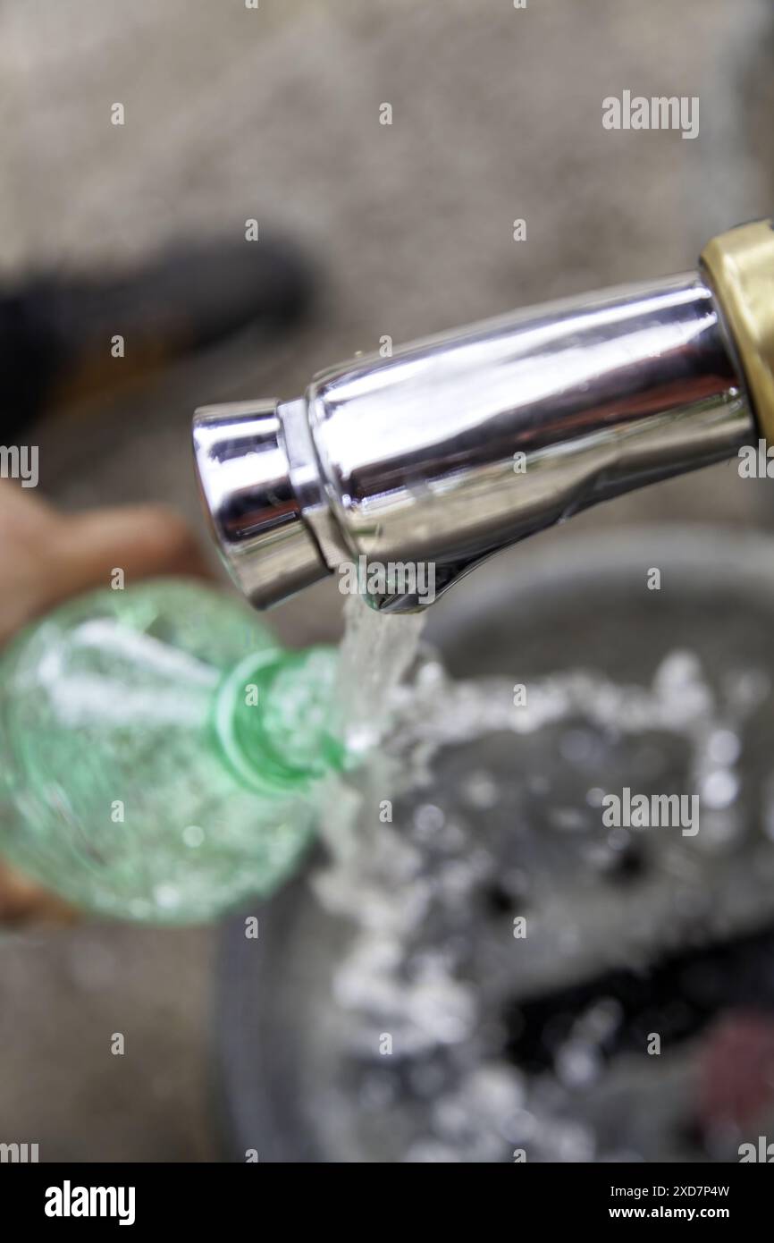 filling a bottle with water at a fountain on the street, thirst Stock ...