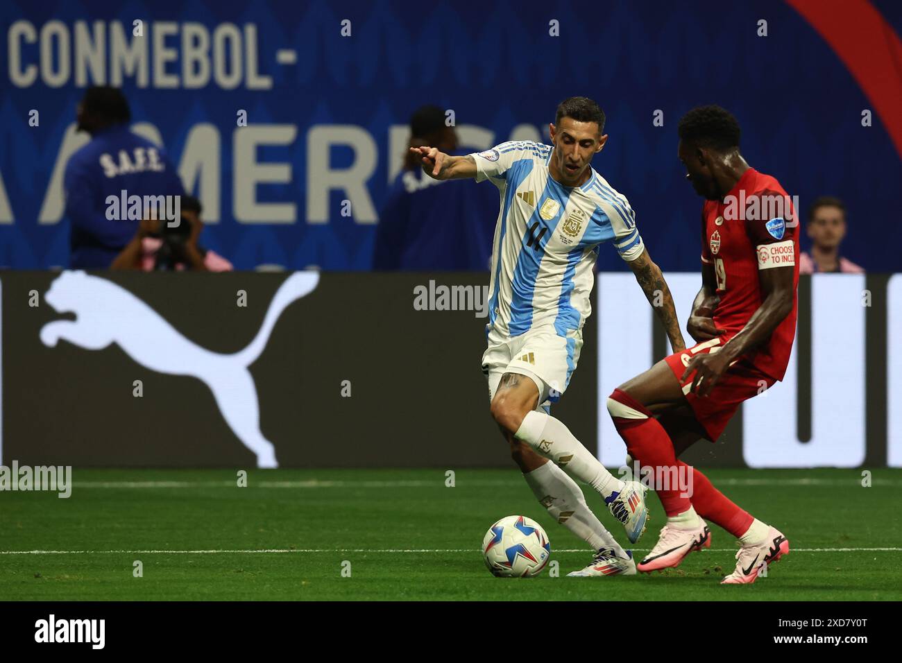 Argentina's forward Angel Di Maria (L) controls the ball past Canada’s ...