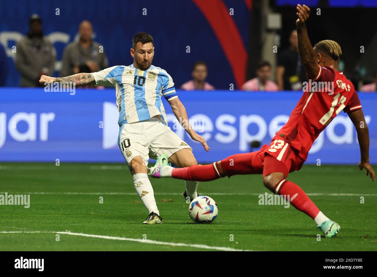 Argentina s forward Lionel Messi L vies for the ball with Canadas defender Derek Cornelius ...