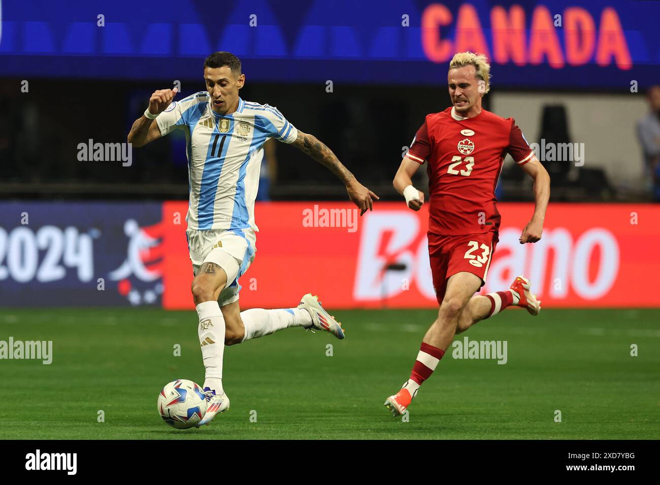 Argentina's forward Angel Di Maria (L) controls the ball past Canada’s ...