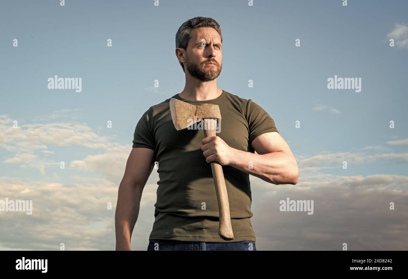 strong man with axe. confident man hold ax. brutal man on sky ...