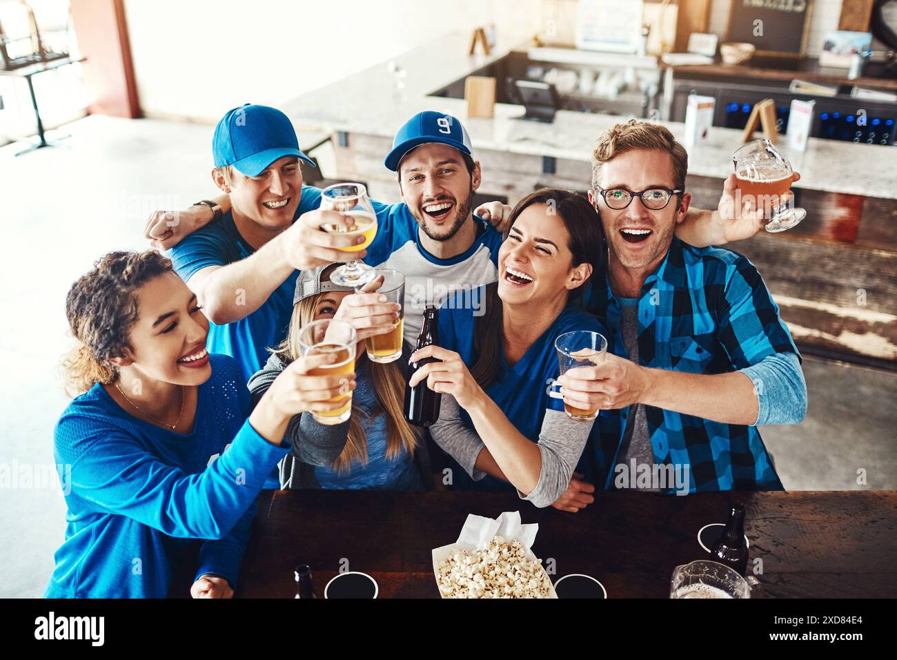 Sports, celebration and friends in pub with beer for support of team ...