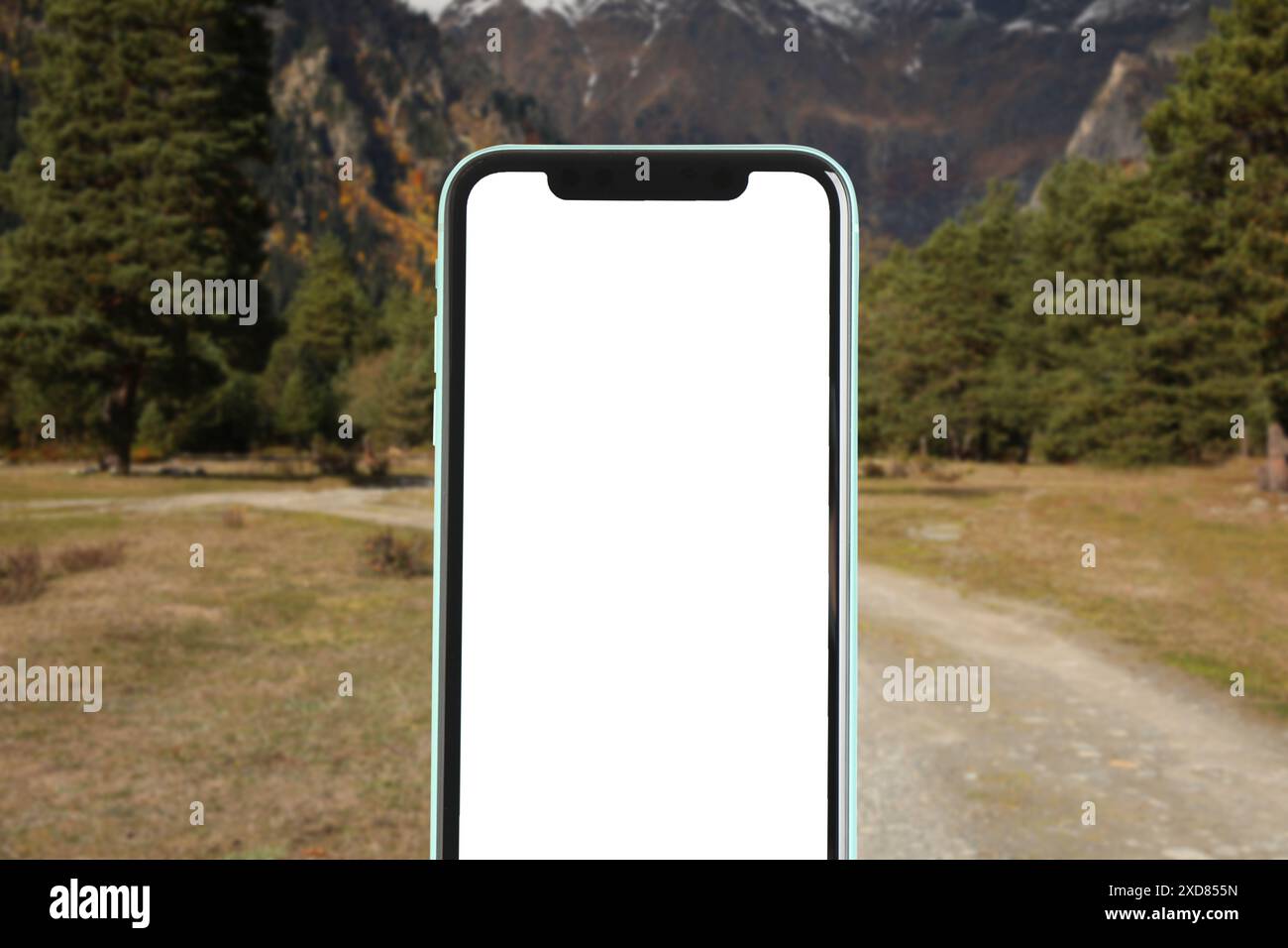 Mobile phone with empty screen against beautiful landscape. Space for ...