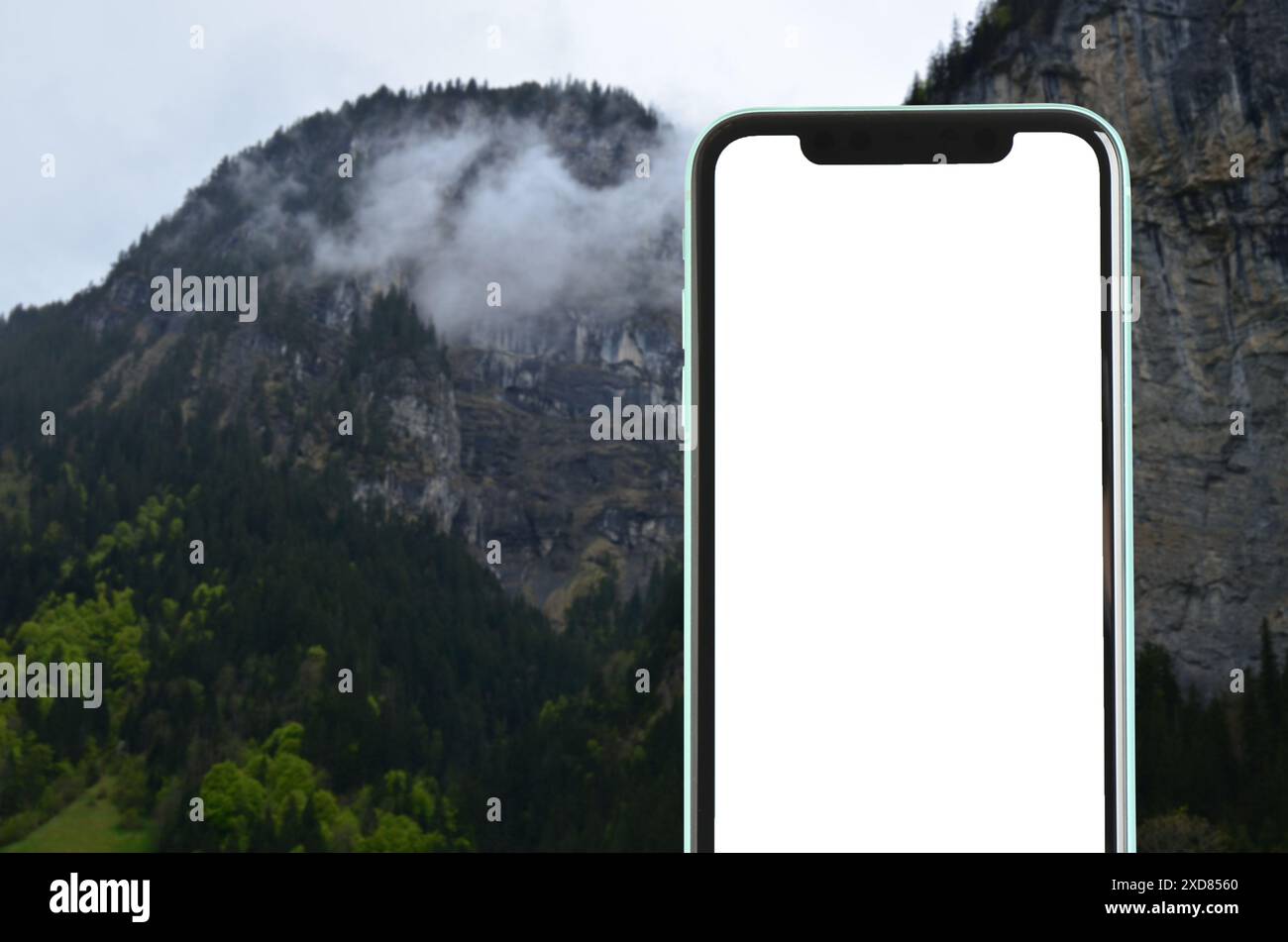 Mobile phone with empty screen against mountain landscape. Space for ...