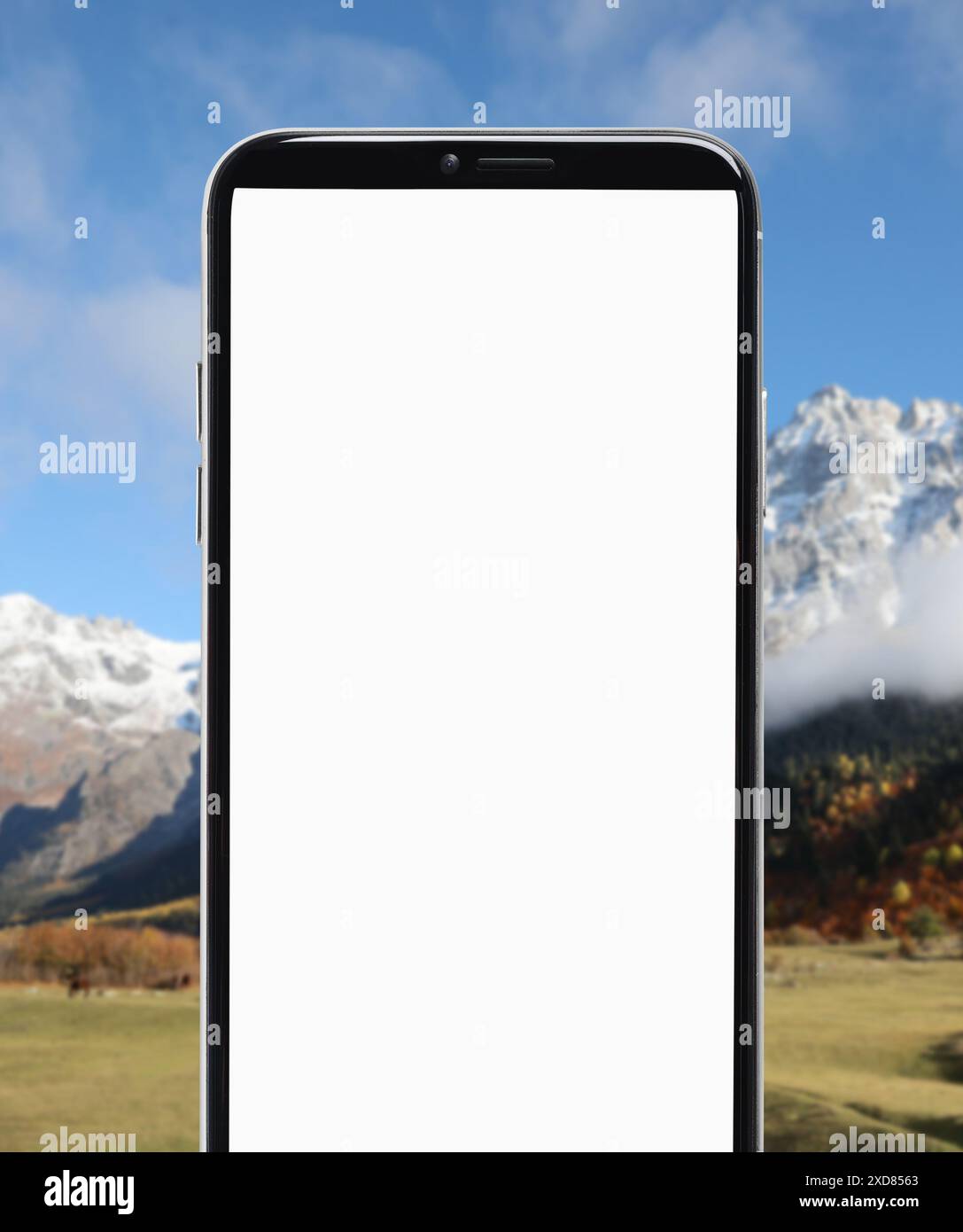 Mobile phone with empty screen against beautiful landscape. Space for ...