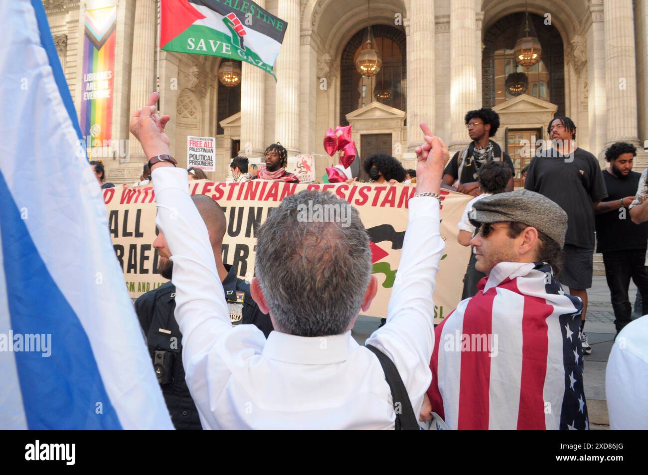 A pro-Israel demonstrator waves his middle fingers at pro-Palestine ...