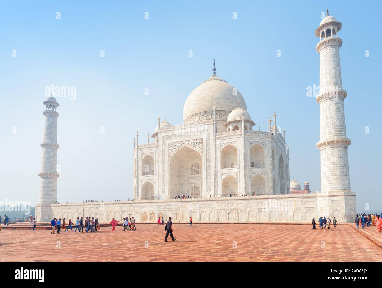Colorful crowds of visitors walking along the Taj Mahal complex in Agra ...
