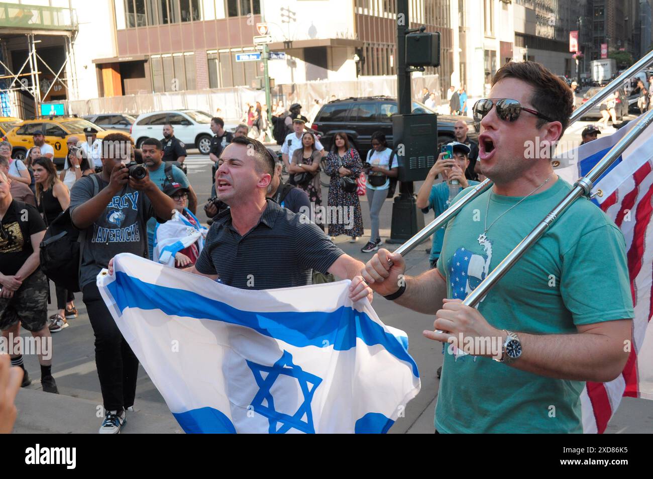 Pro-Israel demonstrators rally waving Israeli and American flags ...